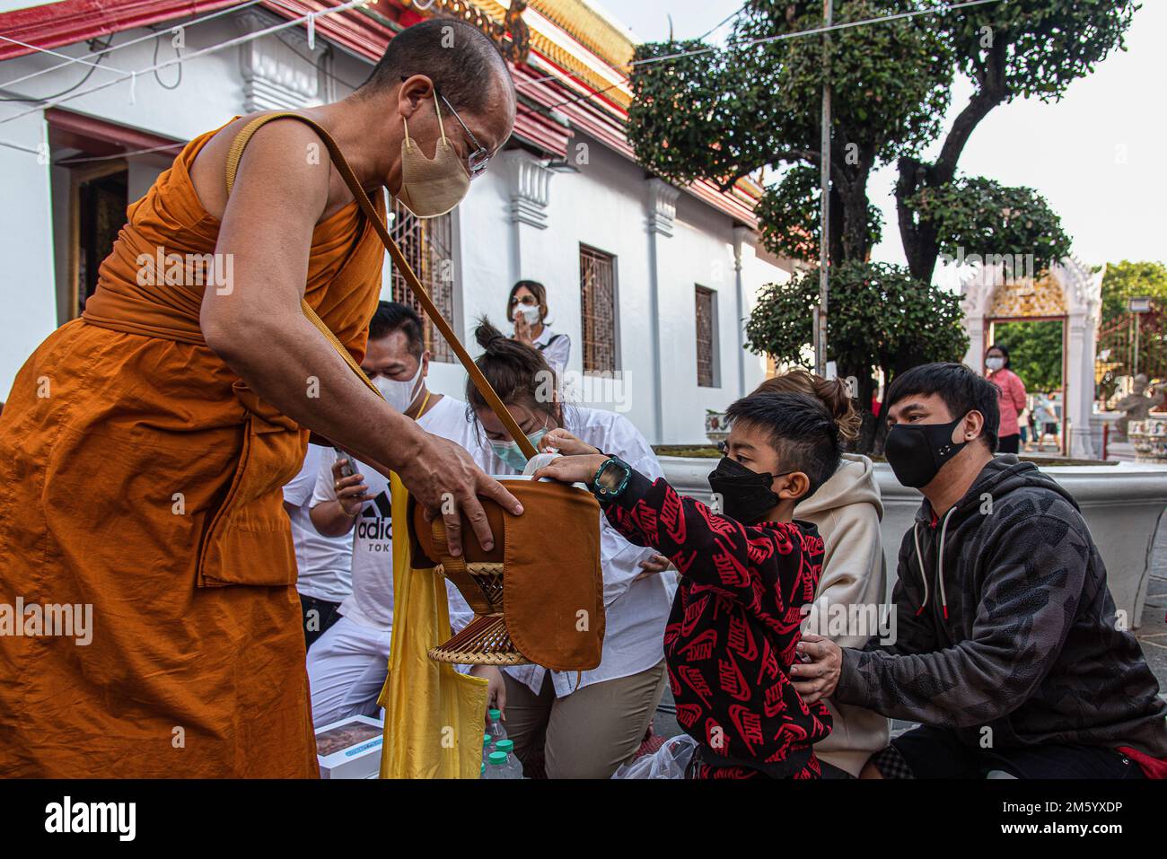 Bangkok, Thailand. 01st Jan, 2023. Buddhist monks receive alms from ...