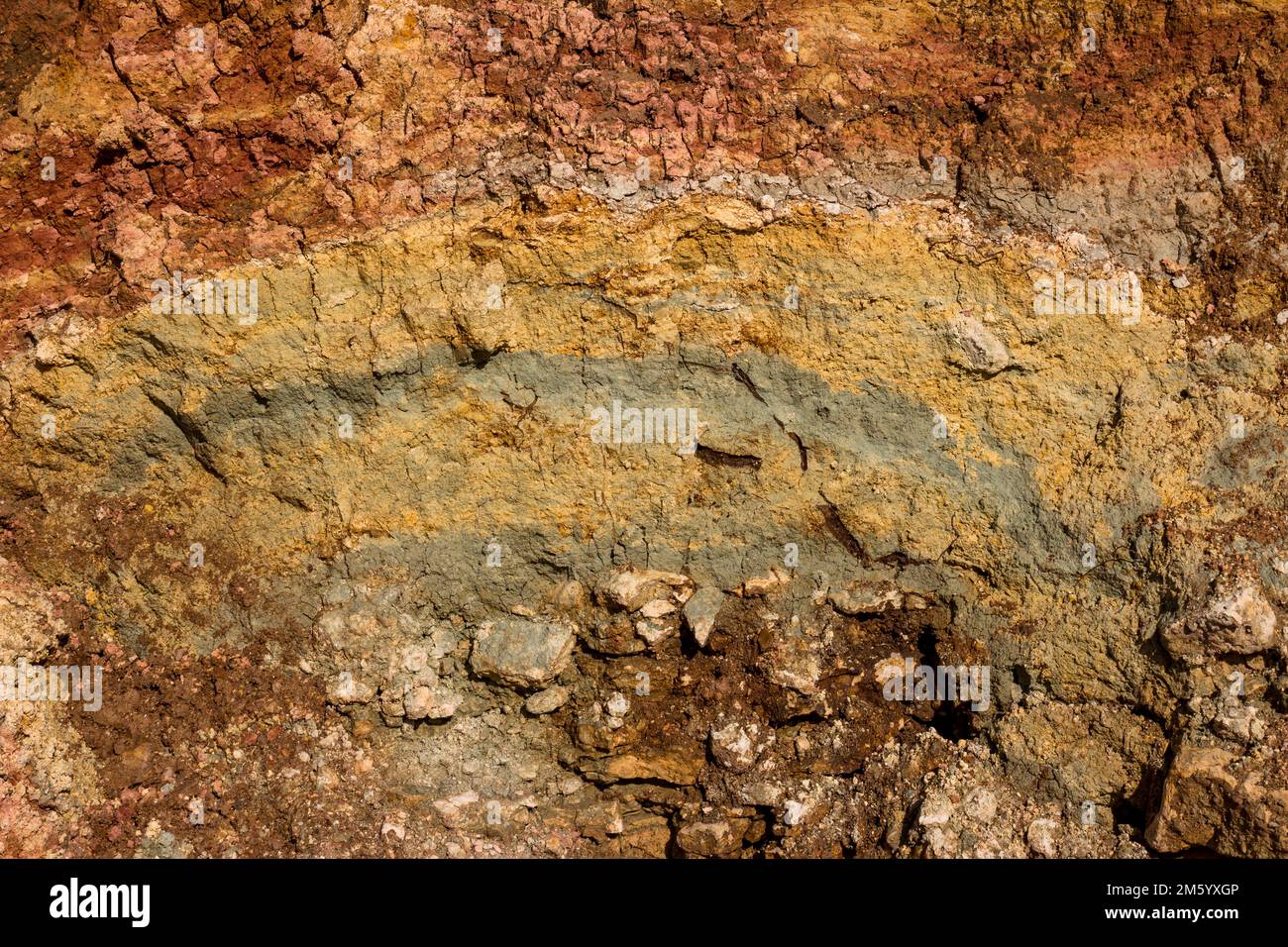 Texture of multi-colored layers of clay coming out in nature Stock ...