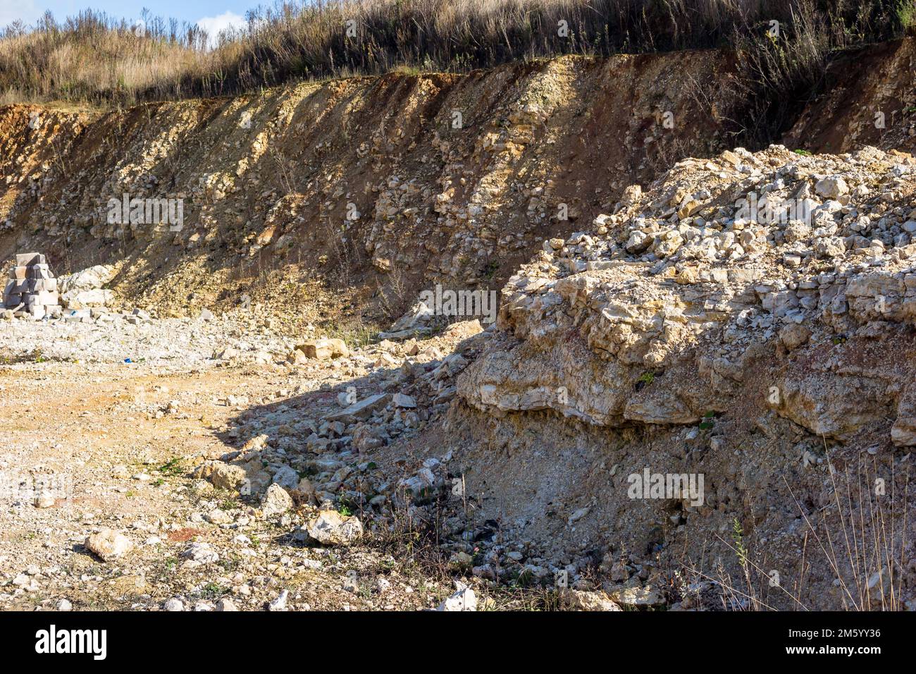 Layers of white limestone in a small stone quarry Stock Photo - Alamy