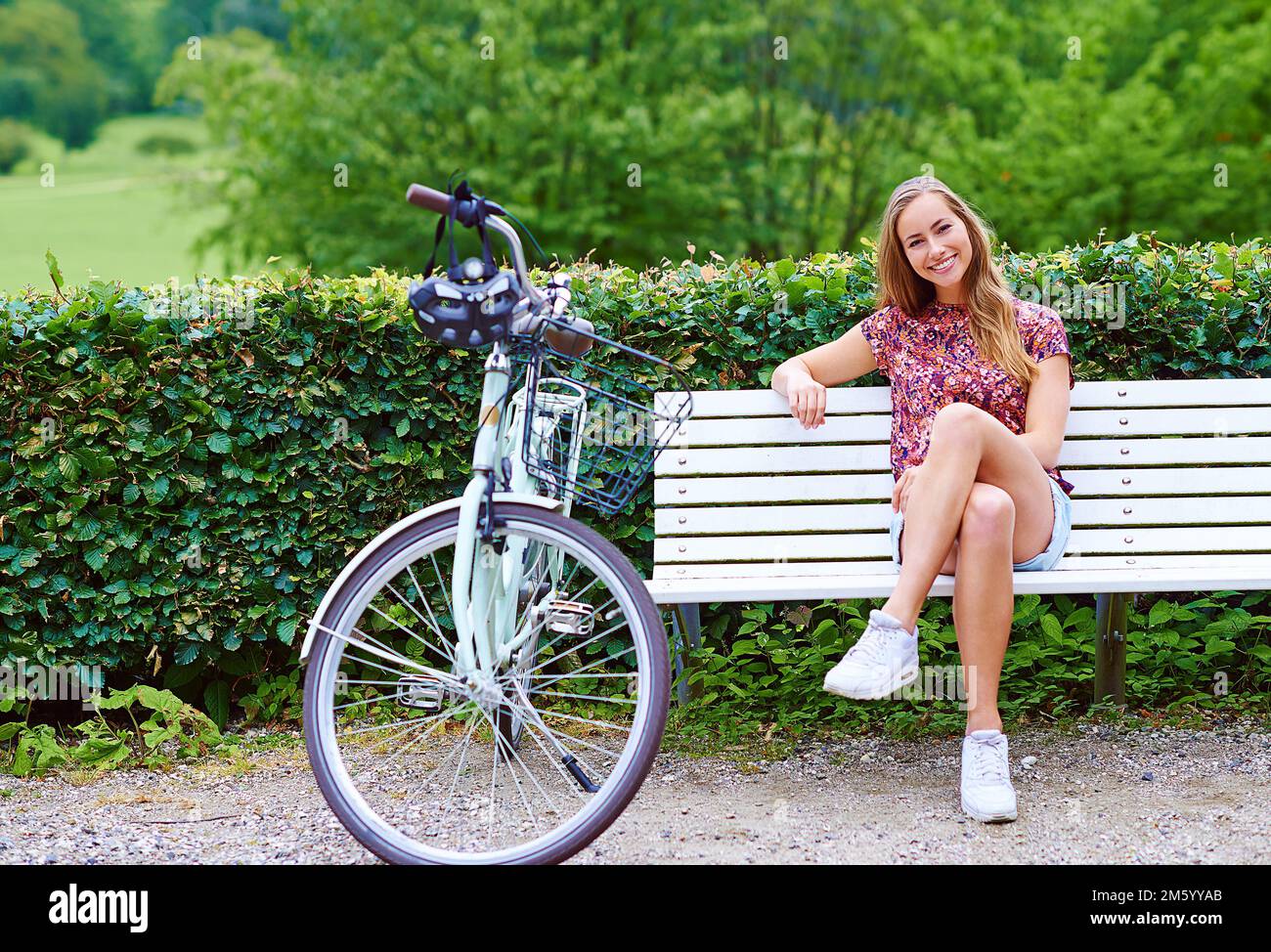 My idea of a great weekend. a young woman sitting on a bench while out ...