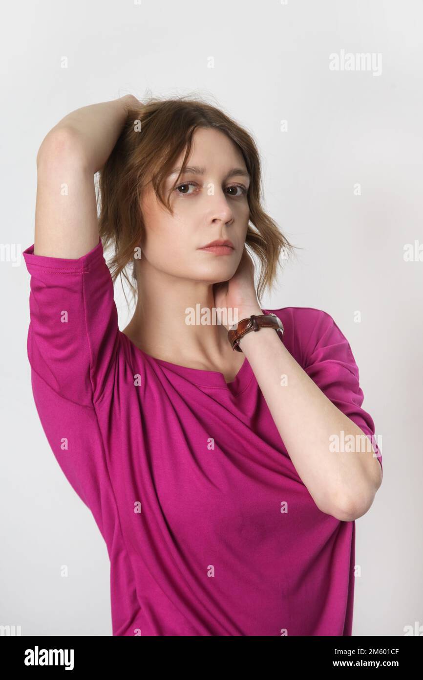 Serie of studio photos of young female model wearing bright pink cotton ...