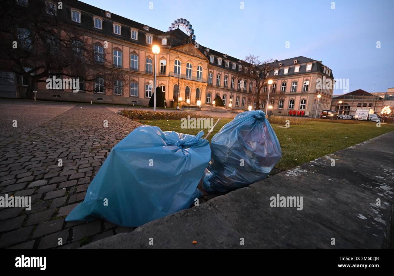 Stuttgart, Germany. 01st Jan, 2023. Garbage bags with leftovers from ...