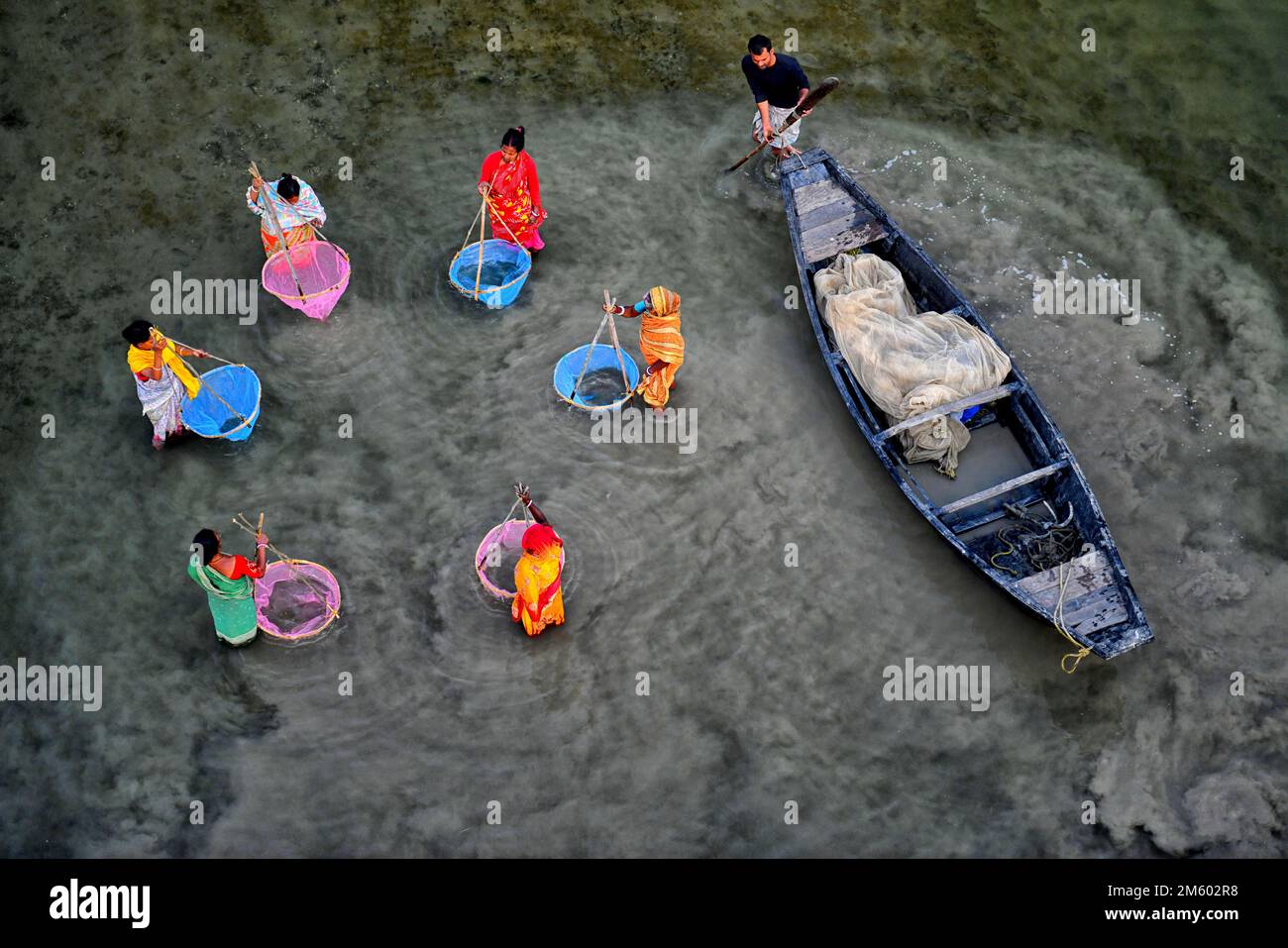 Fisherman family seen using colourful nets during fishing on the Matla ...