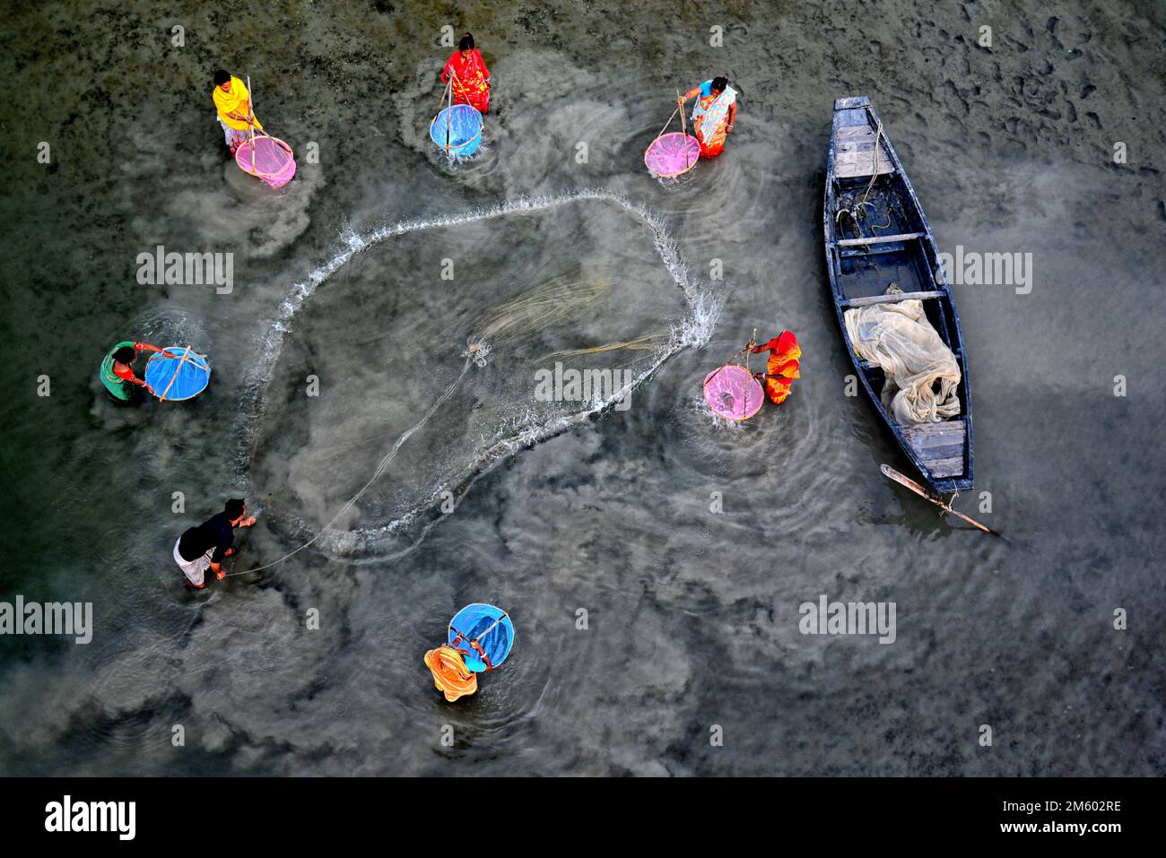 Fisherman family seen using colourful nets during fishing on the Matla ...