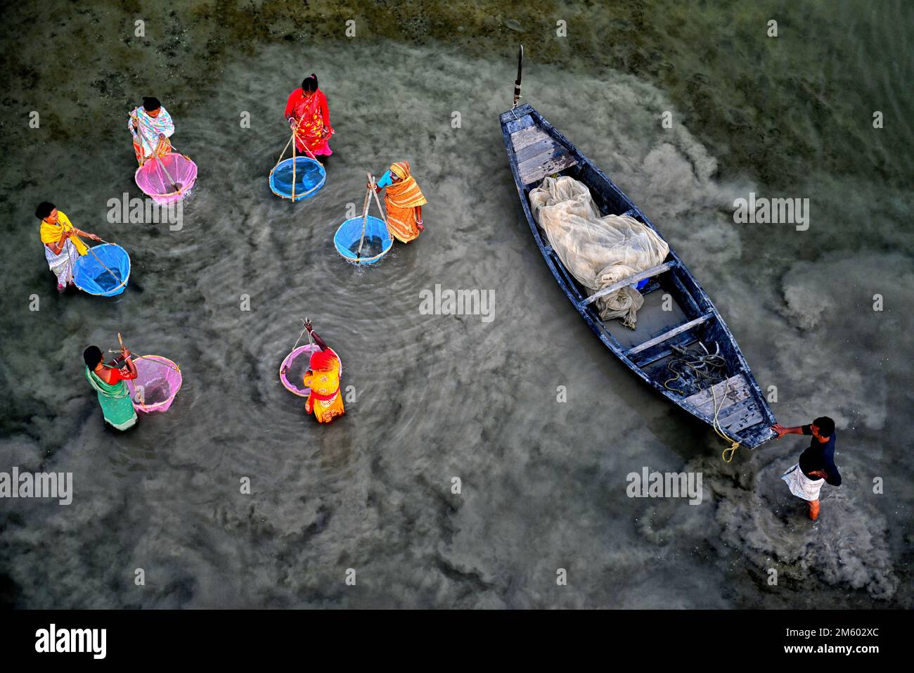Fisherman family seen using colourful nets during fishing on the Matla ...