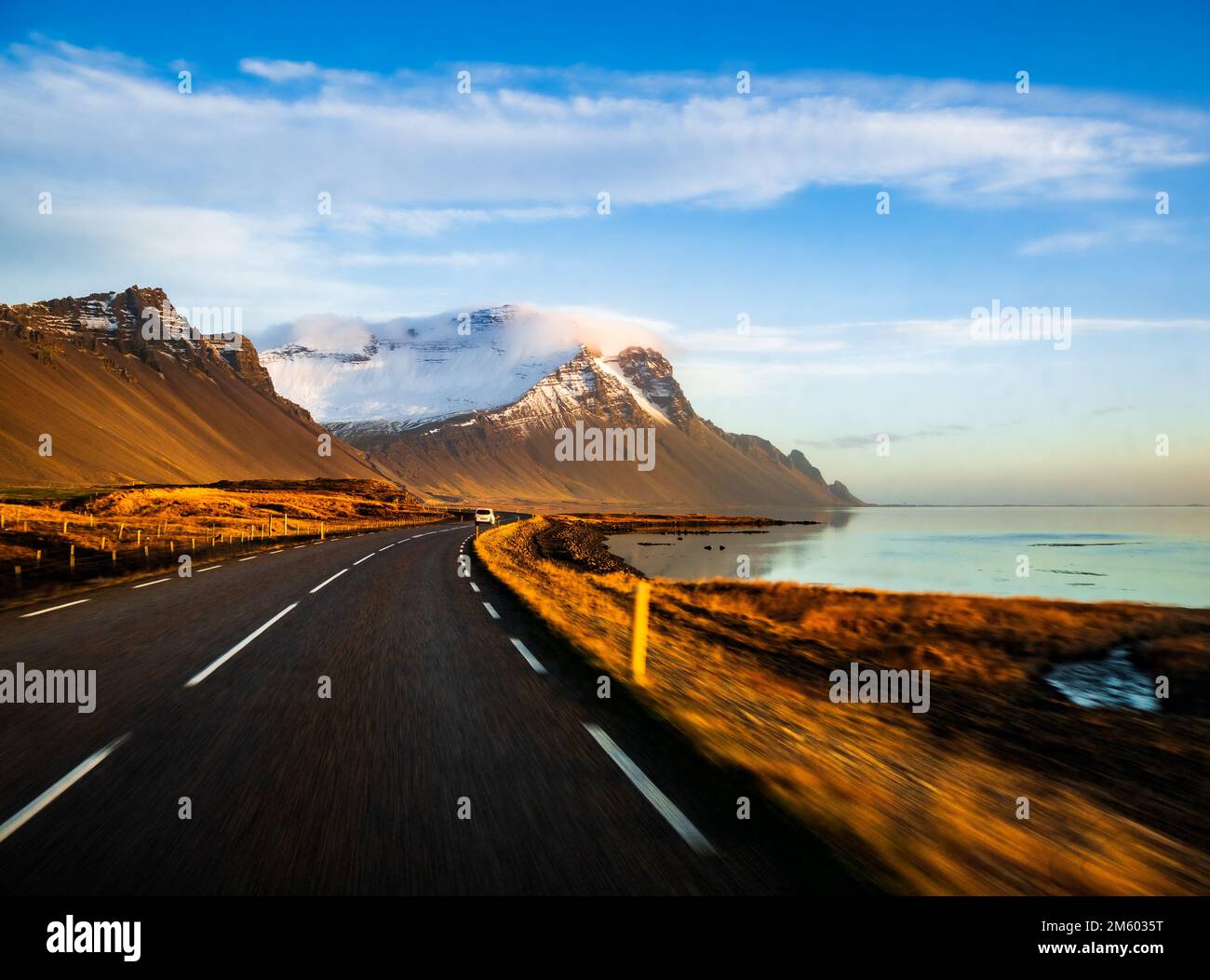 Car moves on the road among the mountains with motion blur foreground ...