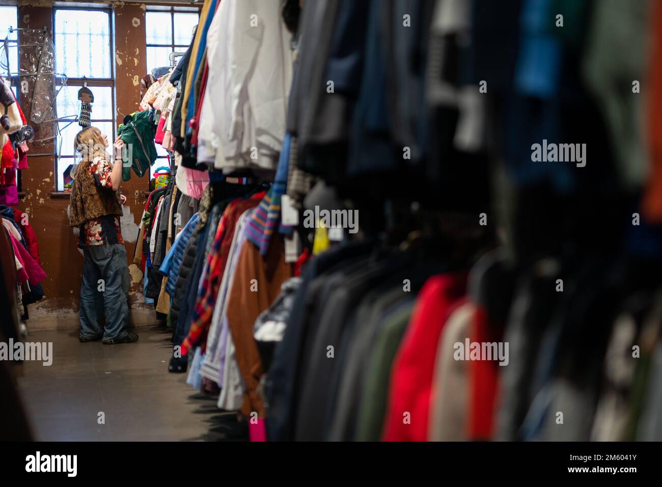 A member of staff organises clothes for sale at the Traid Charity Shop ...