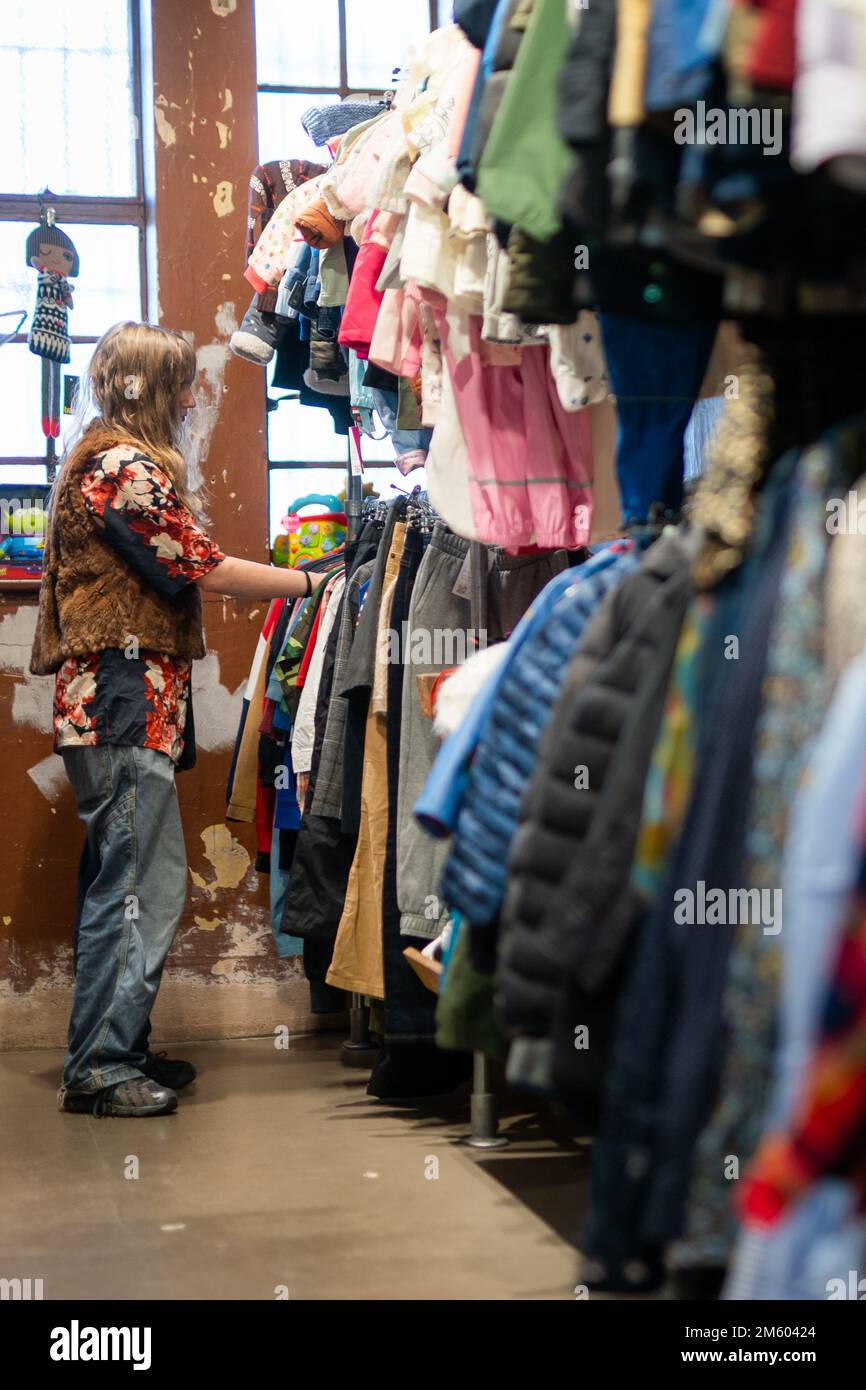 A member of staff organises clothes for sale at the Traid Charity Shop ...