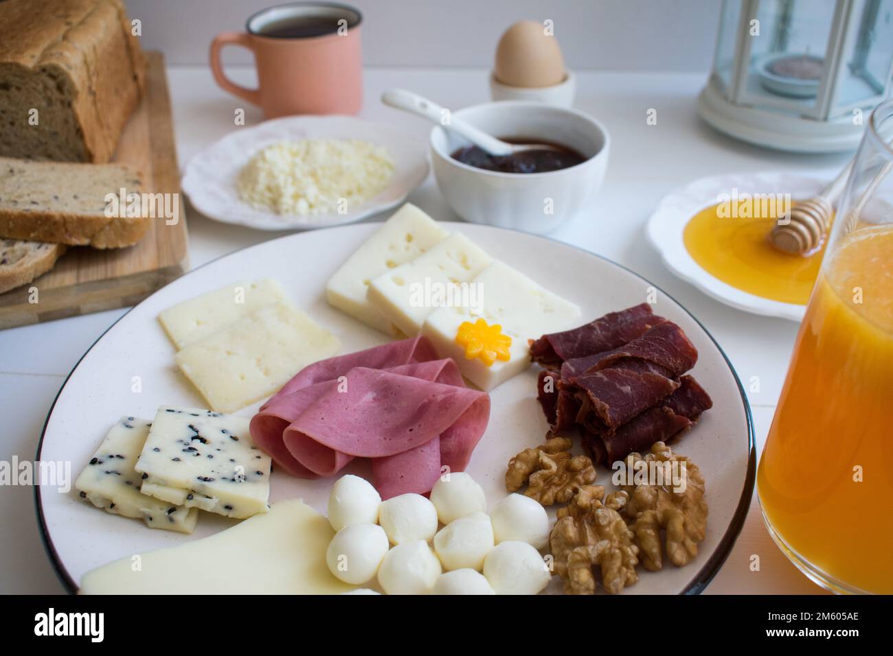 Delicious breakfast presentation, cheese varieties, honey, walnuts ...