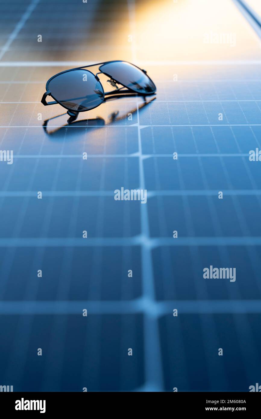 Sunglasses on a solar panel with copy space Stock Photo - Alamy