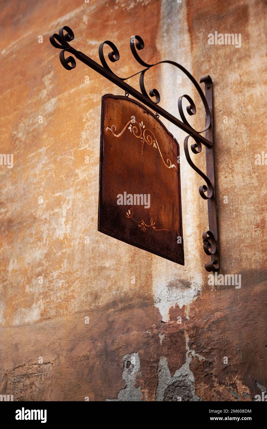 Wrought iron sign on an old wall Stock Photo - Alamy