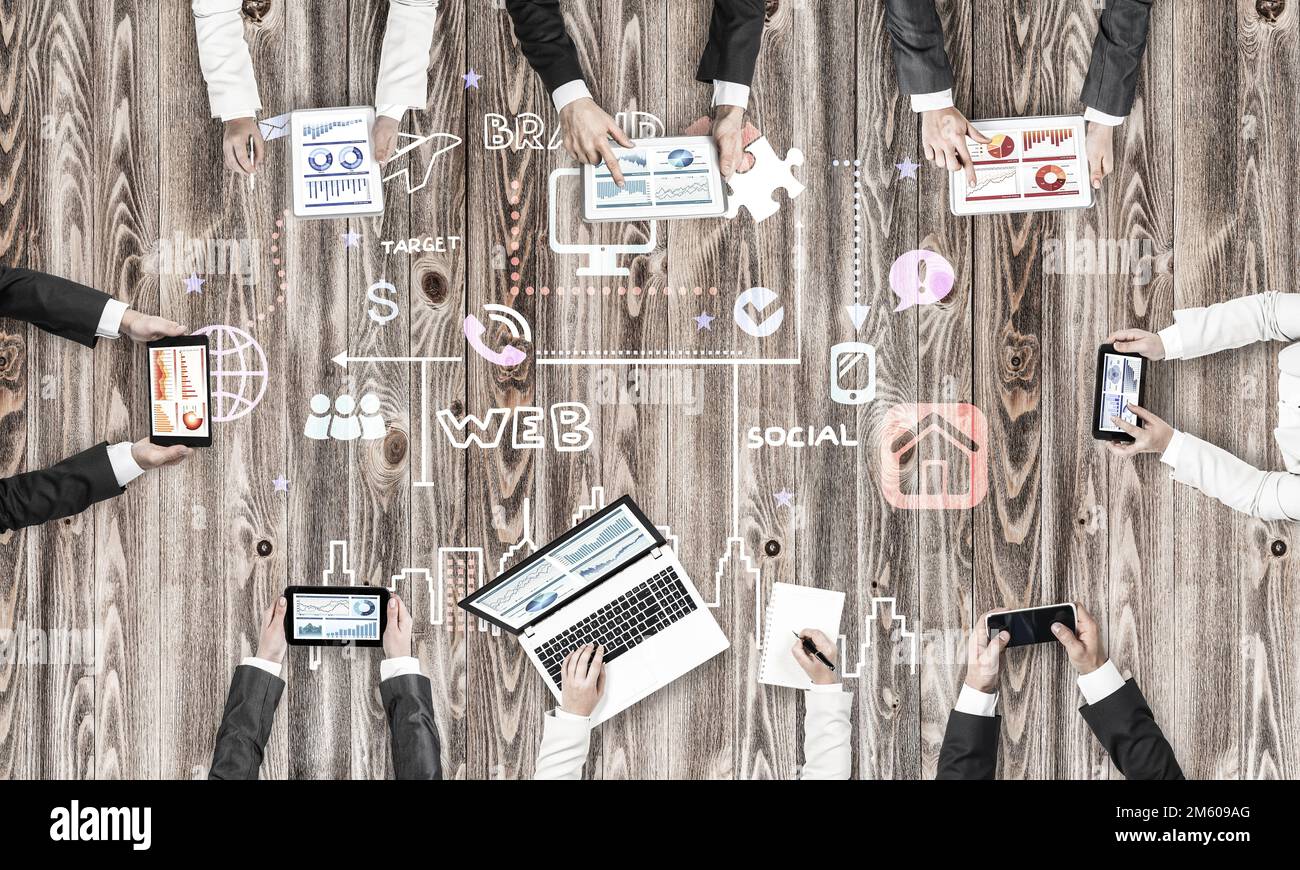 Top view of businesspeople sitting at table and using gadgets Stock ...
