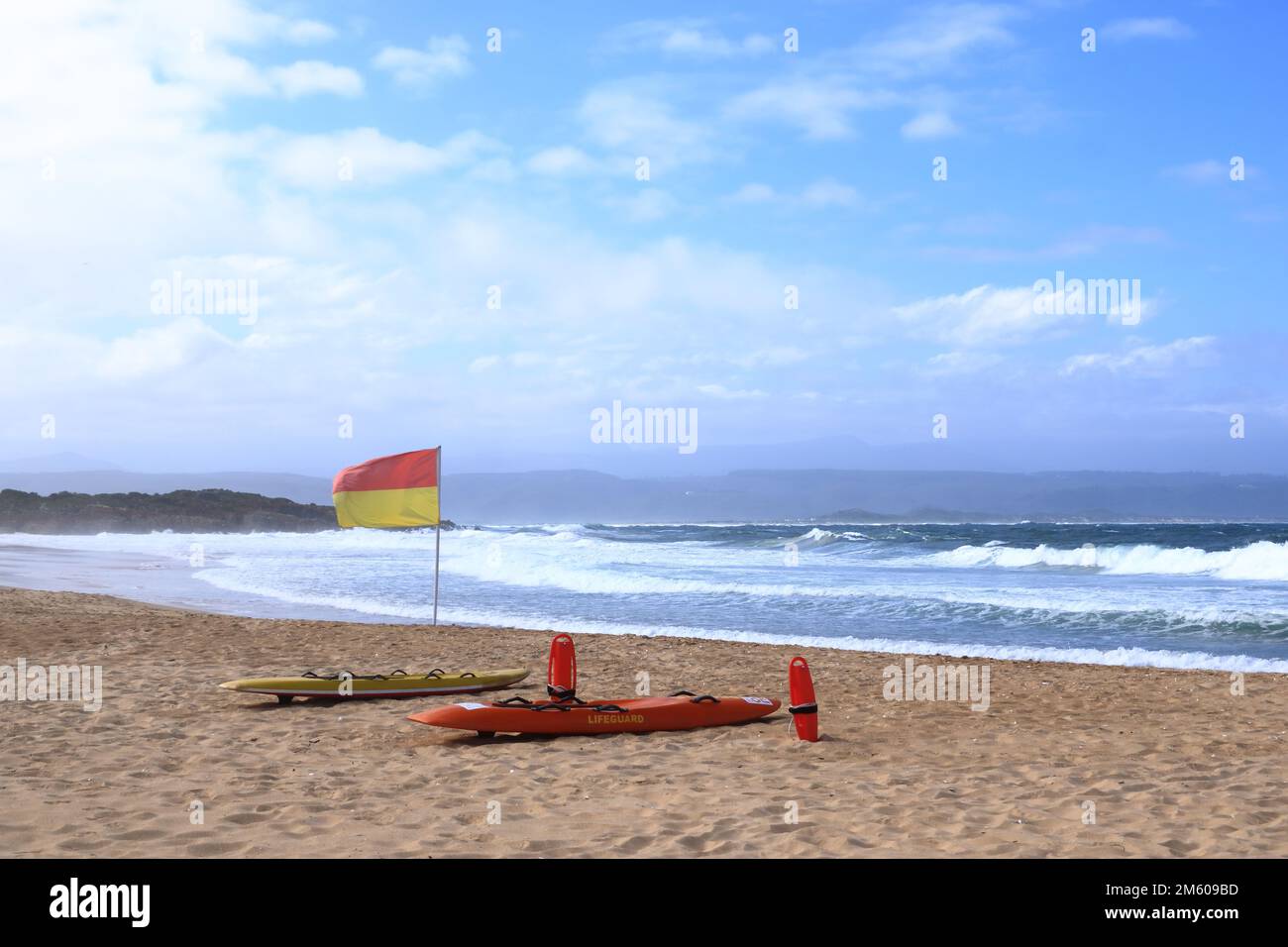 Lifeguard equipment in yellow and red colors and shark danger on the ...