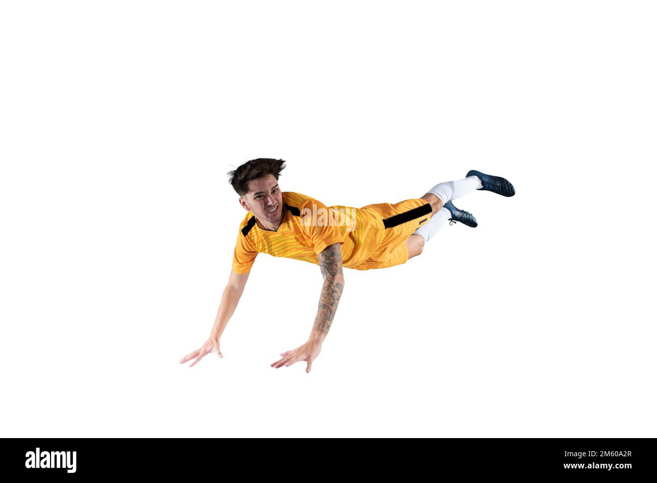 Football striker player with yellow team suit jumps Stock Photo - Alamy