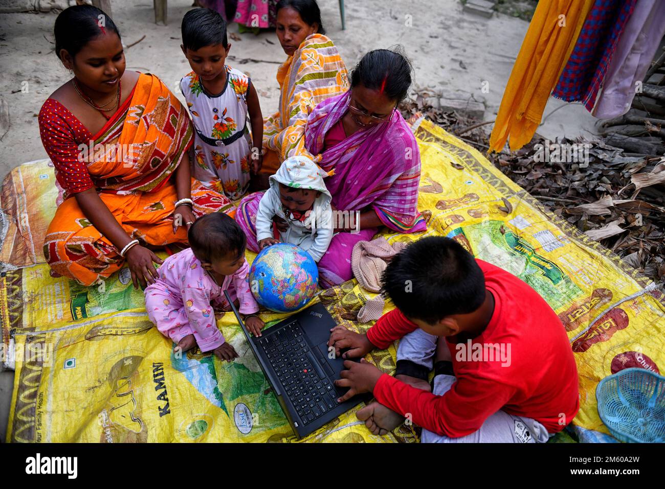 Canning, India. 31st Dec, 2022. Little children use laptop and a globe ...