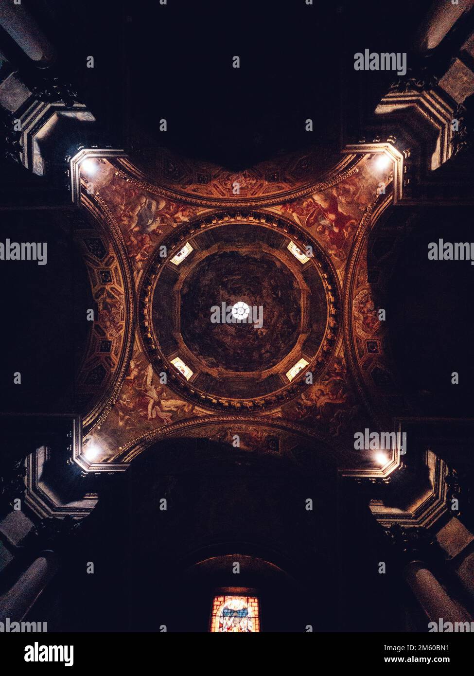 A vertical shot of a historic church roof with spot light illumination ...