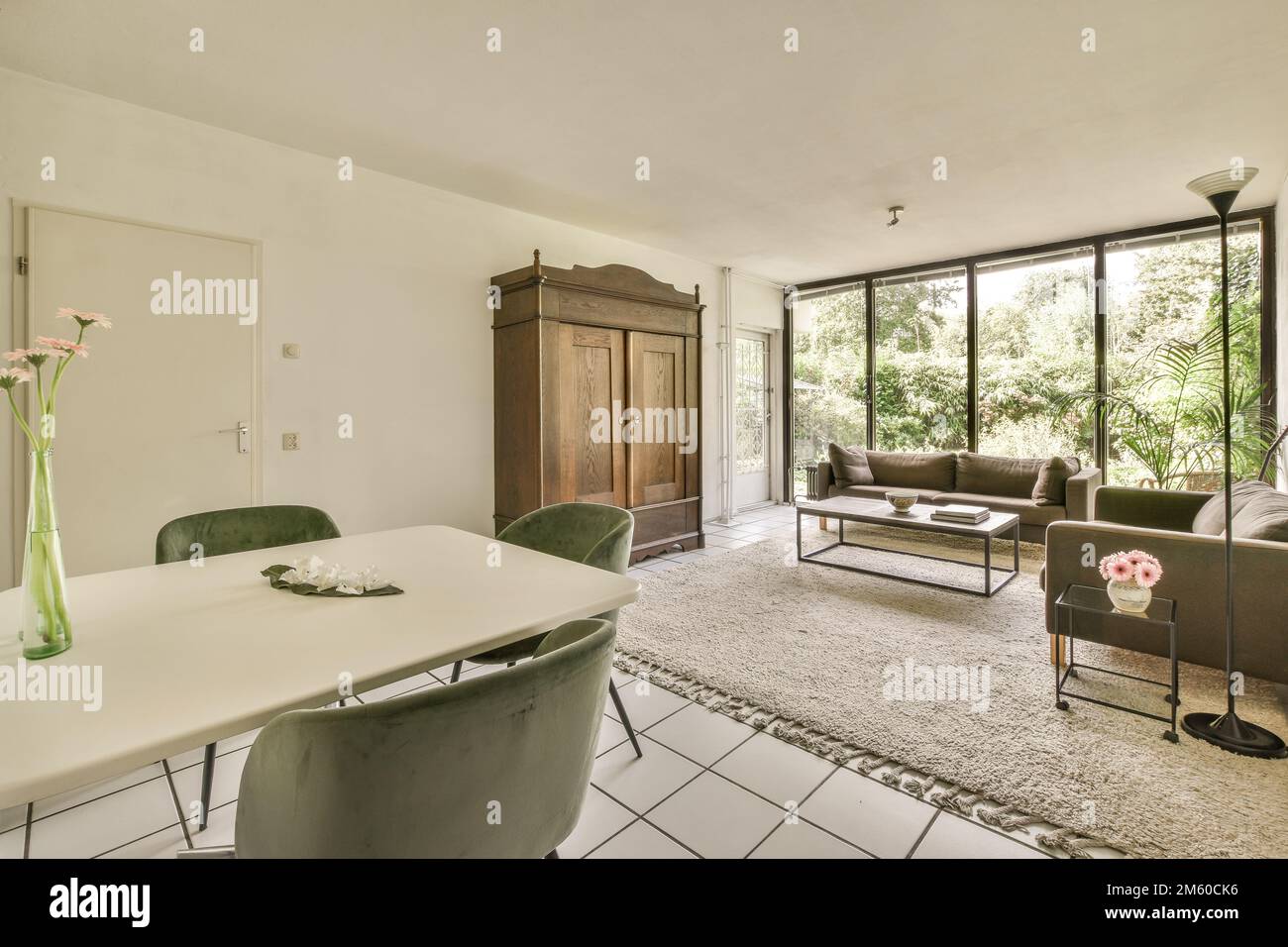 a living room with couches, chairs and a table in front of a sliding ...