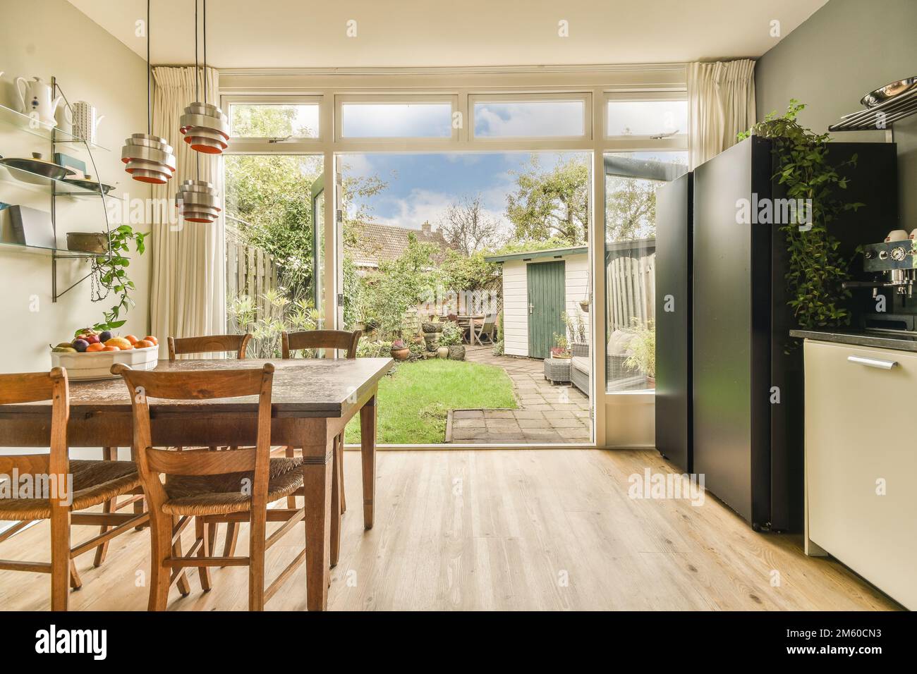 a kitchen and dining area in a house with sliding glass doors that open ...