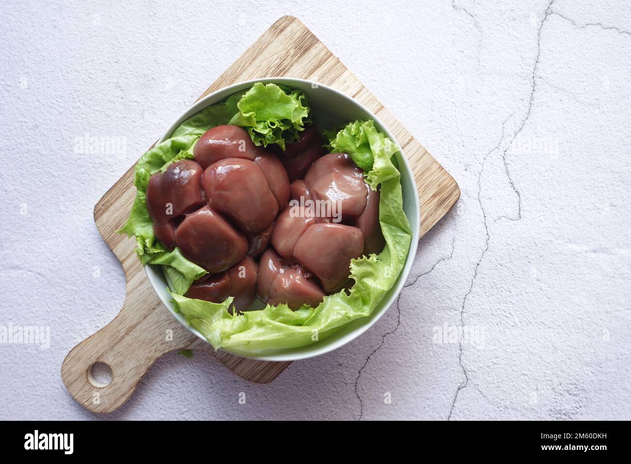 Raw fresh lamb kidneys on a chopping board Stock Photo - Alamy