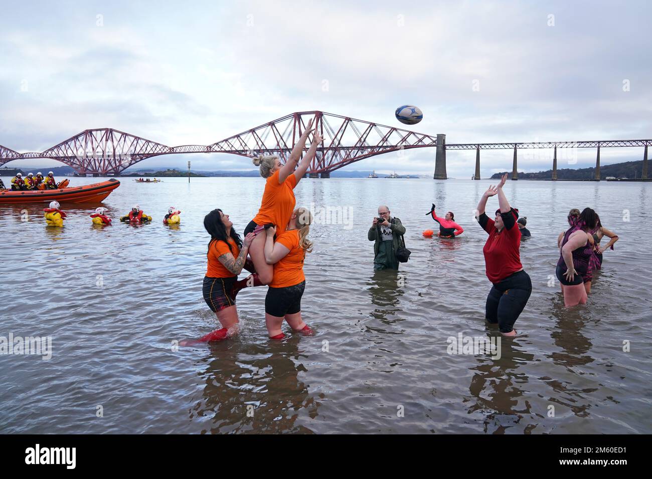 People stage a rugby line out as they take part in the Loony Dook New ...