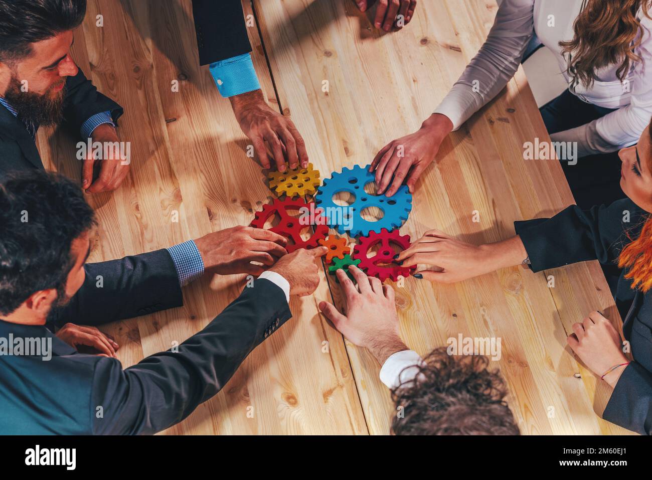 Business team connect pieces of colorful gears like a teamwork and ...