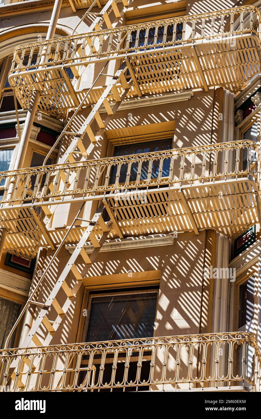 Typical house with exterior stairs, fire escapes, drop shadow on facade ...