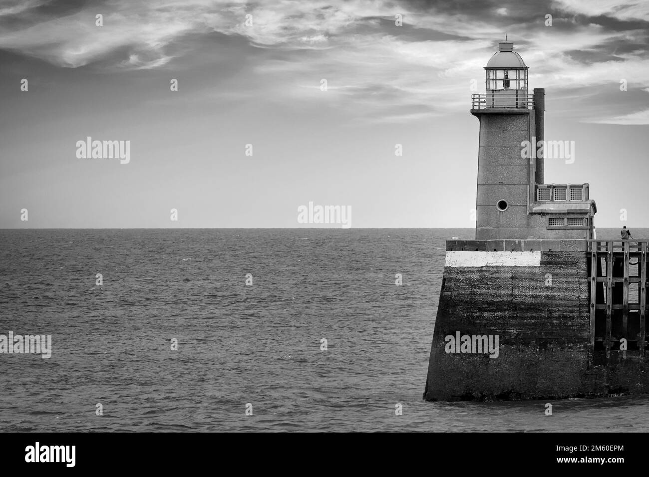 Lighthouse at the harbour entrance, Pointe Fagnet, evening sky, black ...