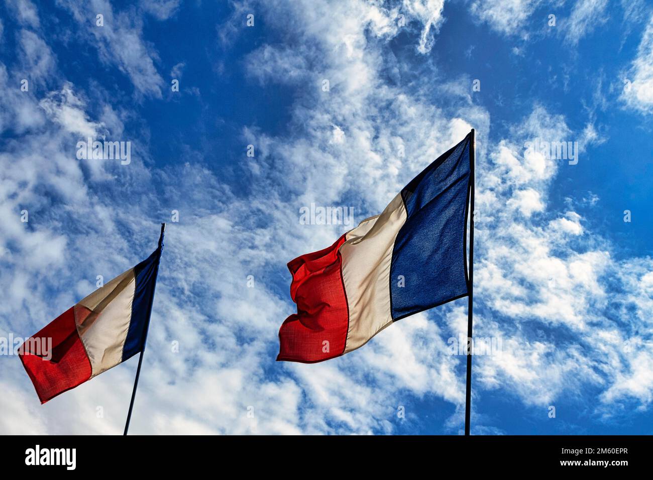 Two French national flags fluttering side by side in the wind ...