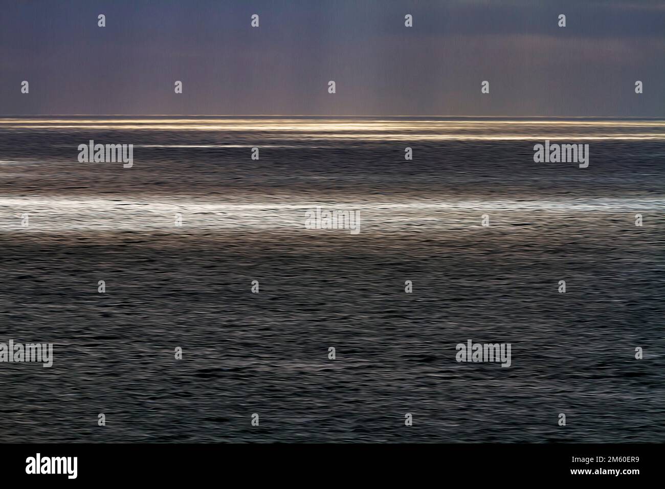 Sunbeams through cloud cover, sunlight glistening on the sea, evening ...