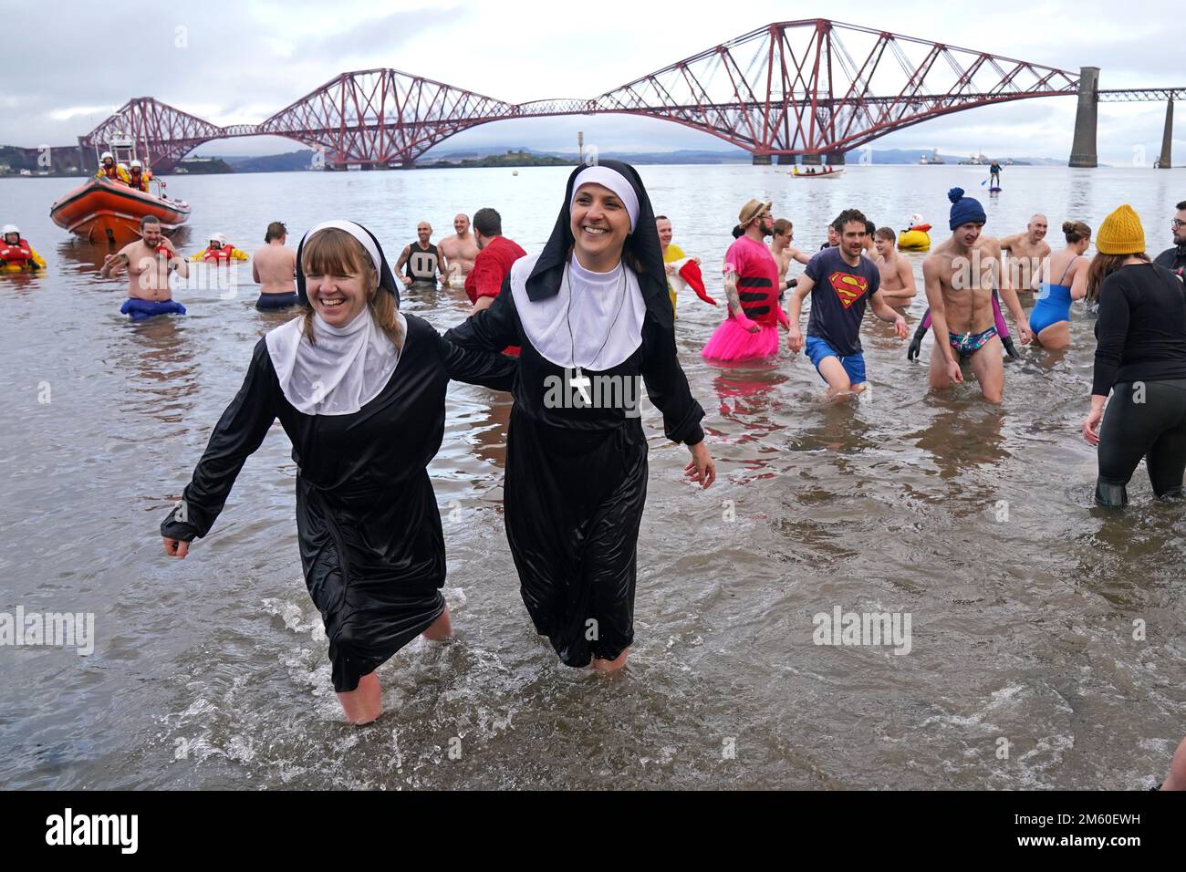 People take part in the Loony Dook New Year's Day dip in the Firth of ...