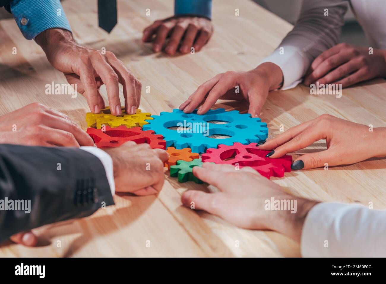 Business team connect pieces of colorful gears like a teamwork and ...