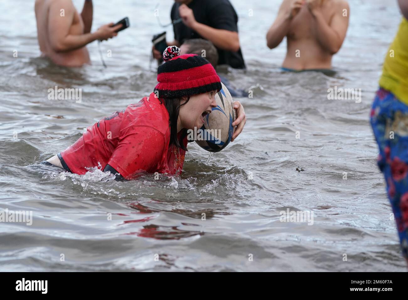 People take part in the Loony Dook New Year's Day dip in the Firth of ...
