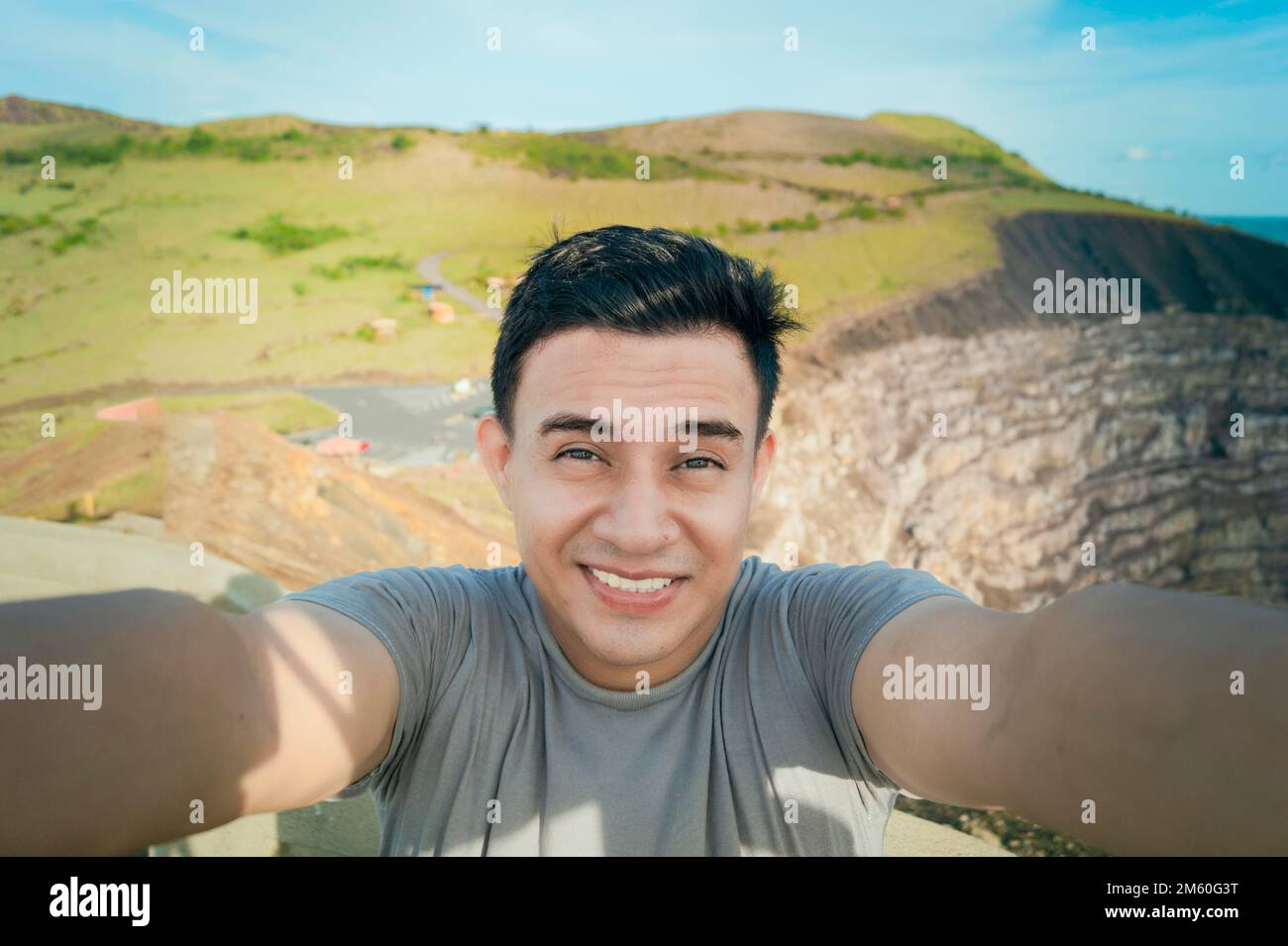 Adventurous man taking a selfie at a viewpoint. Close up of person ...