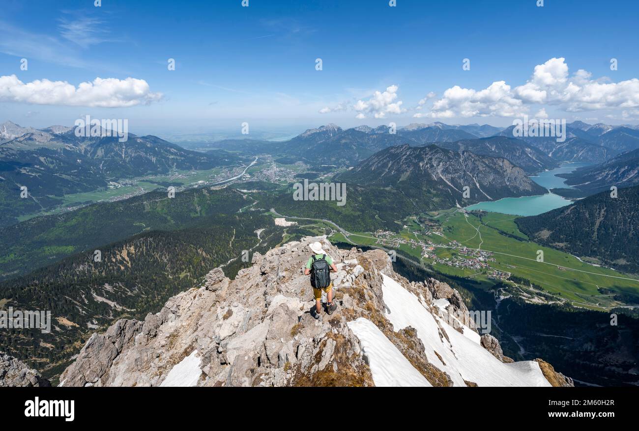 Hikers at the summit of Thaneller, view of mountains with Plansee and ...