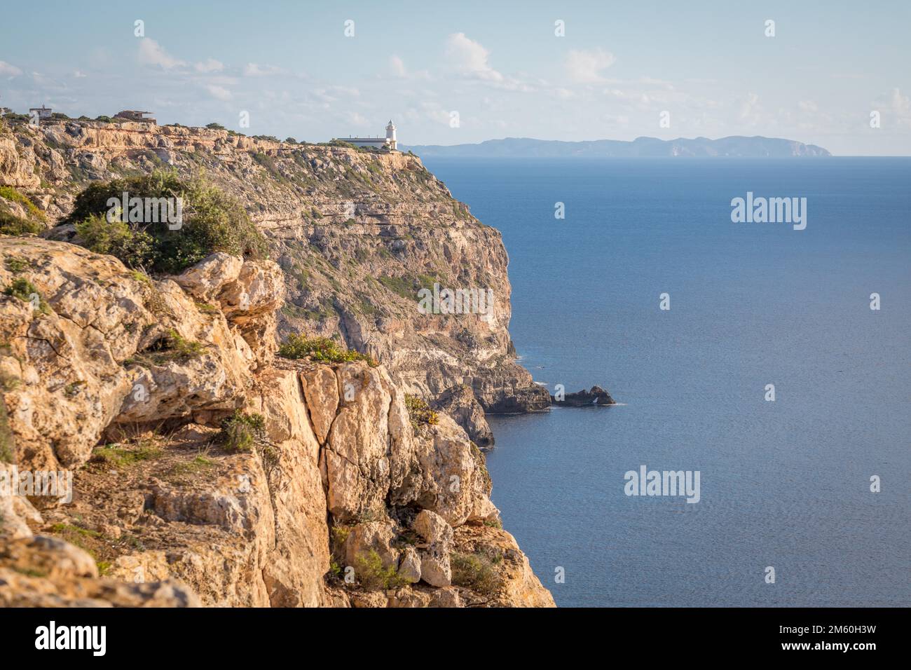 View of cliff with lighthouse Far de Cap Blanc in the south of Majorca ...