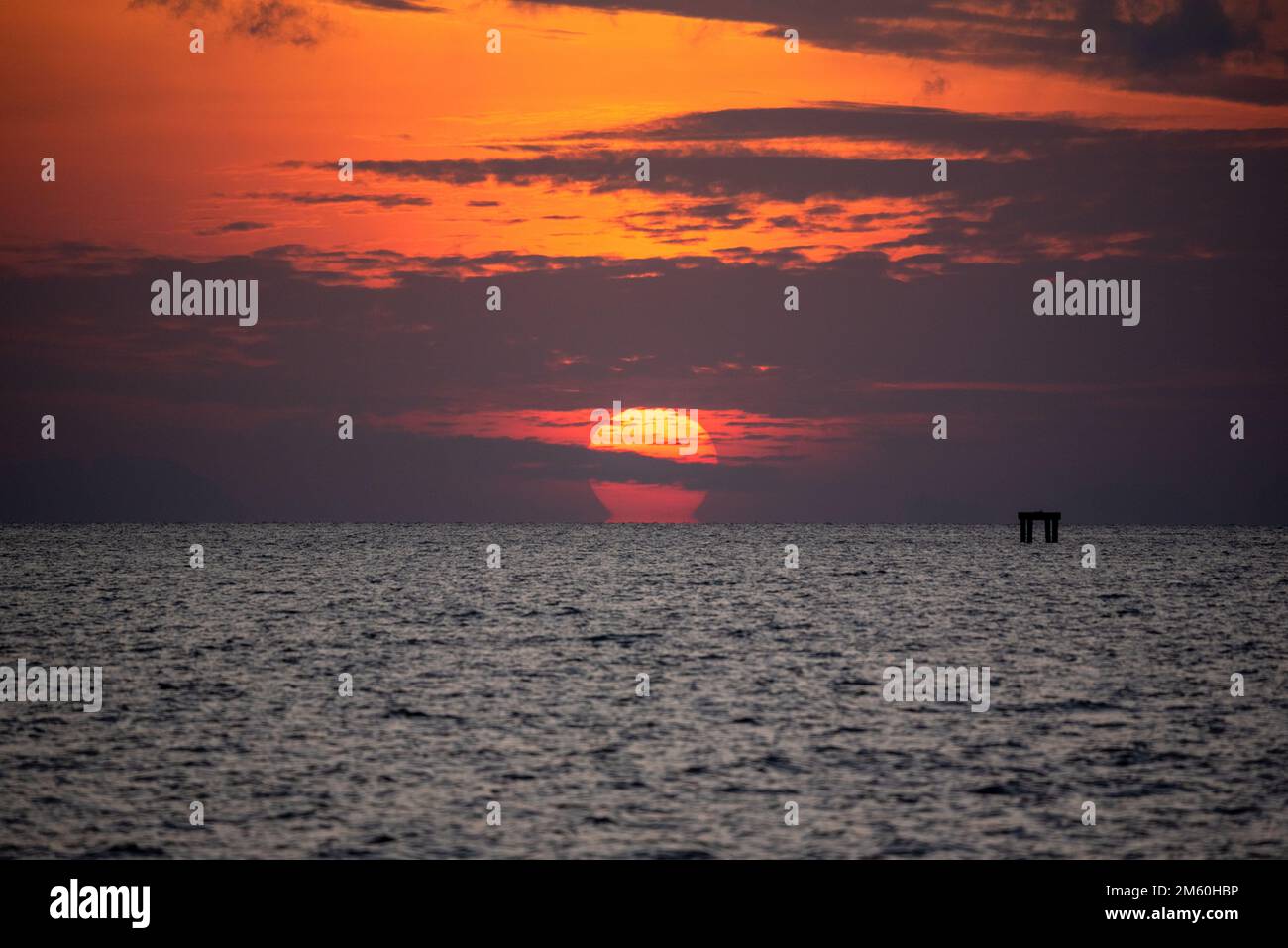 Beautiful omega sunrise and clouds in the sea at Phuket city, Thailand ...