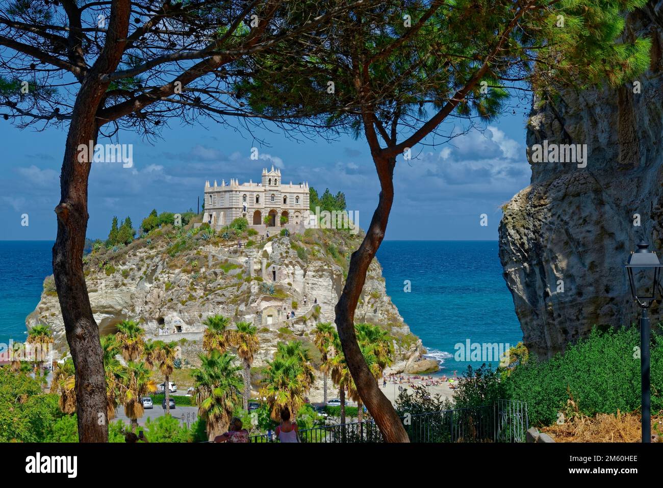 View through pine trees to the medieval church Santuario di Santa Maria ...