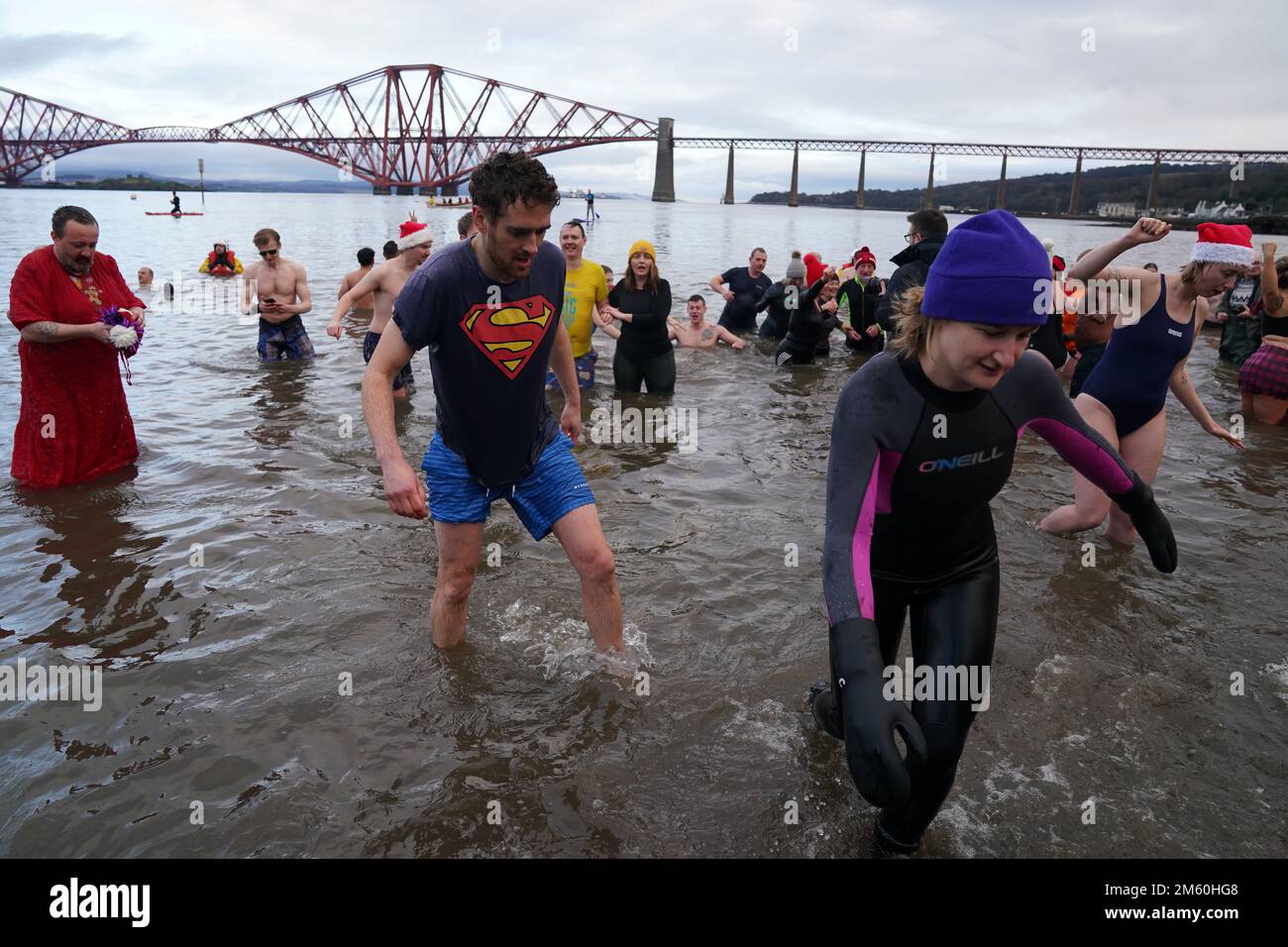 People take part in the Loony Dook New Year's Day dip in the Firth of ...