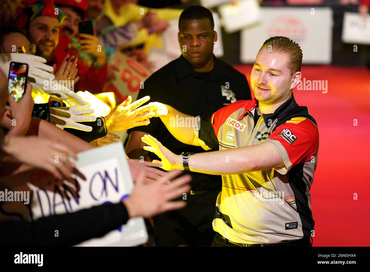 Dimitri Van den Bergh walks out to play against Jonny Clayton during ...