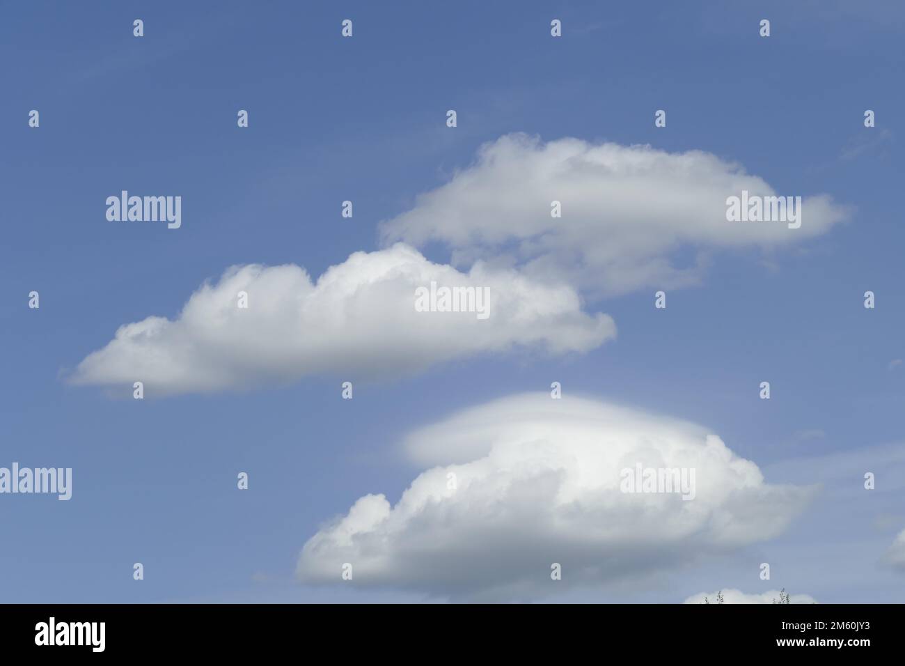 White spring clouds, blue sky, Germany Stock Photo - Alamy