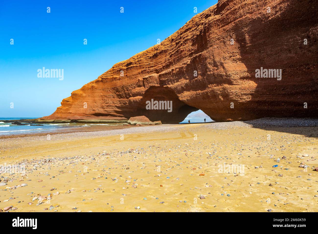 Natural rock coastal arch erosional landform on beach, Legzira ...