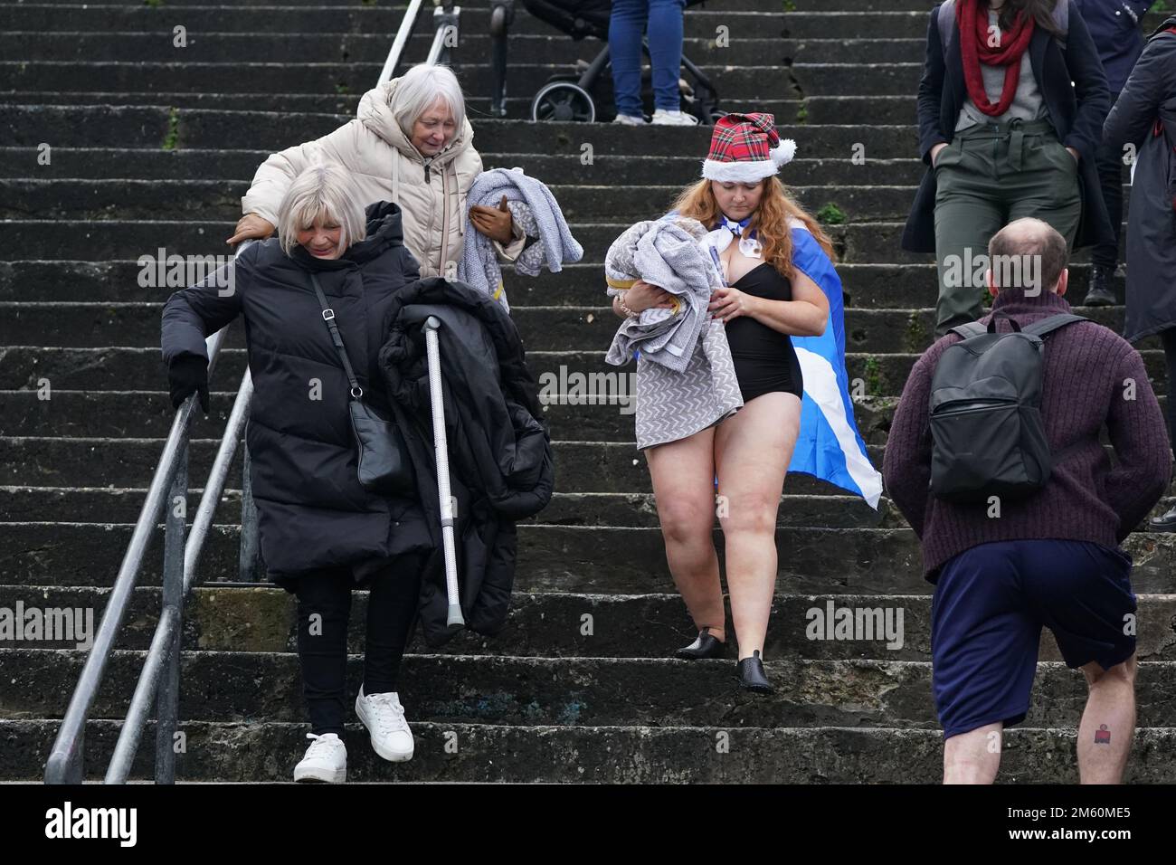 People take part in the Loony Dook New Year's Day dip in the Firth of ...