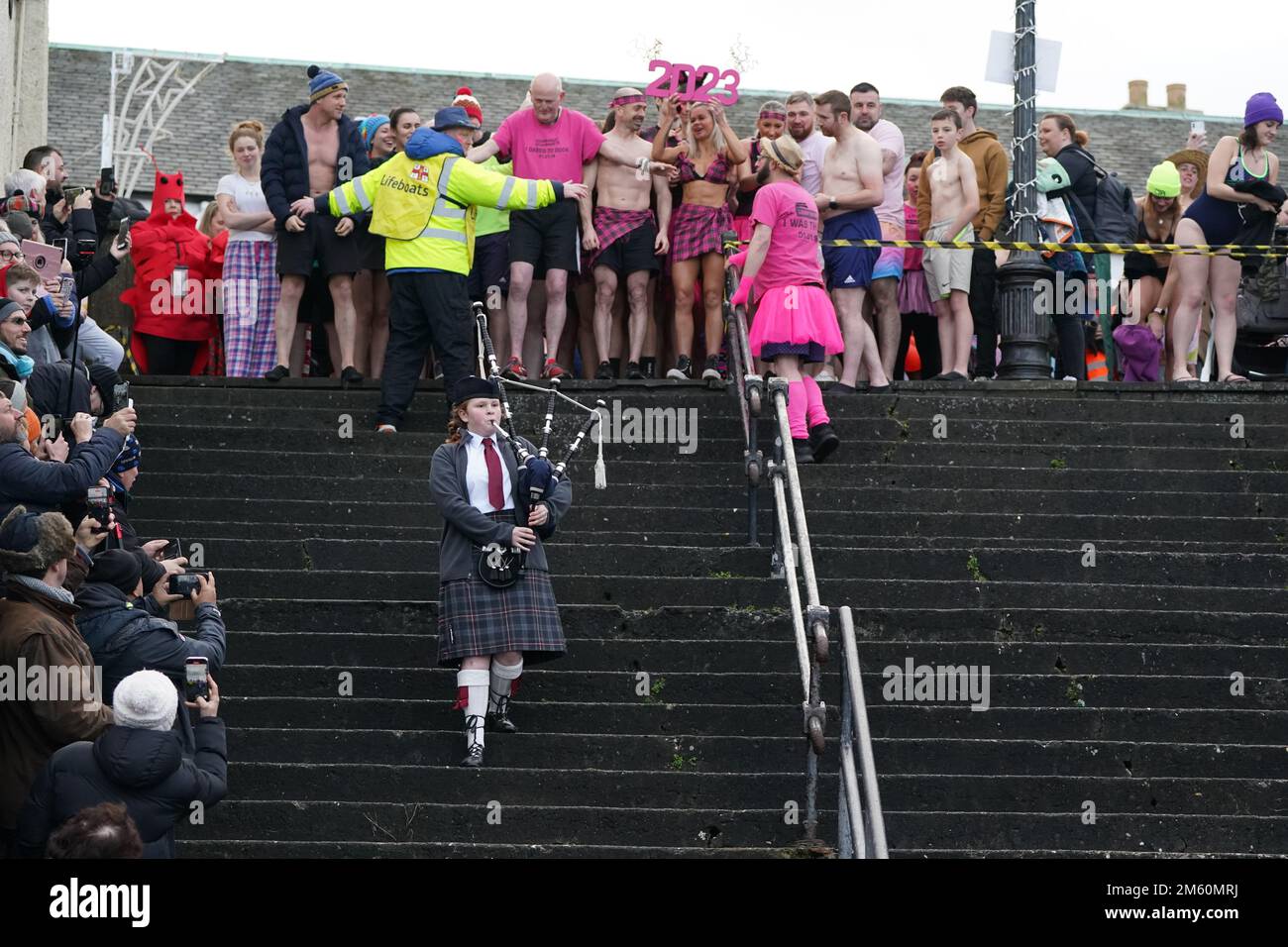 People take part in the Loony Dook New Year's Day dip in the Firth of ...