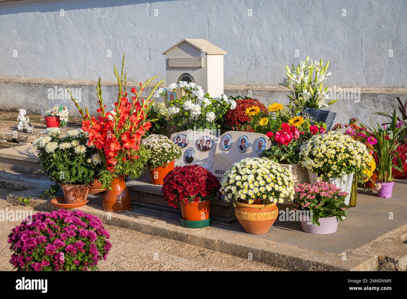 Decorated gravesite on All Saints' Day at Llubi Cemetery, Llubi ...