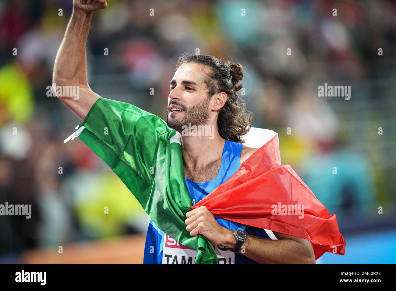 Gianmarco Tamberi with his country's flag after winning the high jump ...