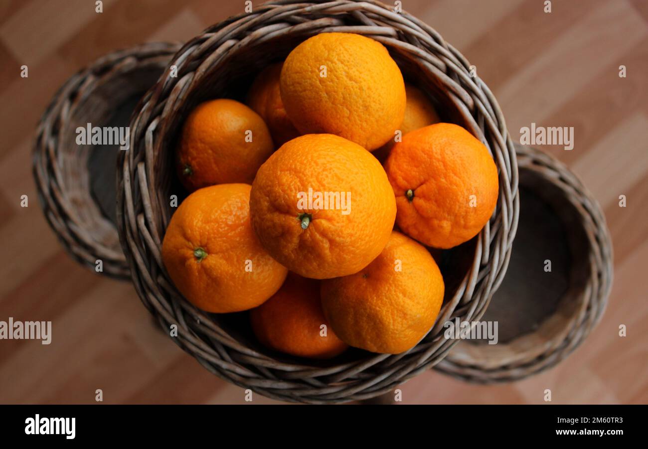 Ripe Mandarin Fruits In A Wicker Pot Top View Stock Photo - Alamy