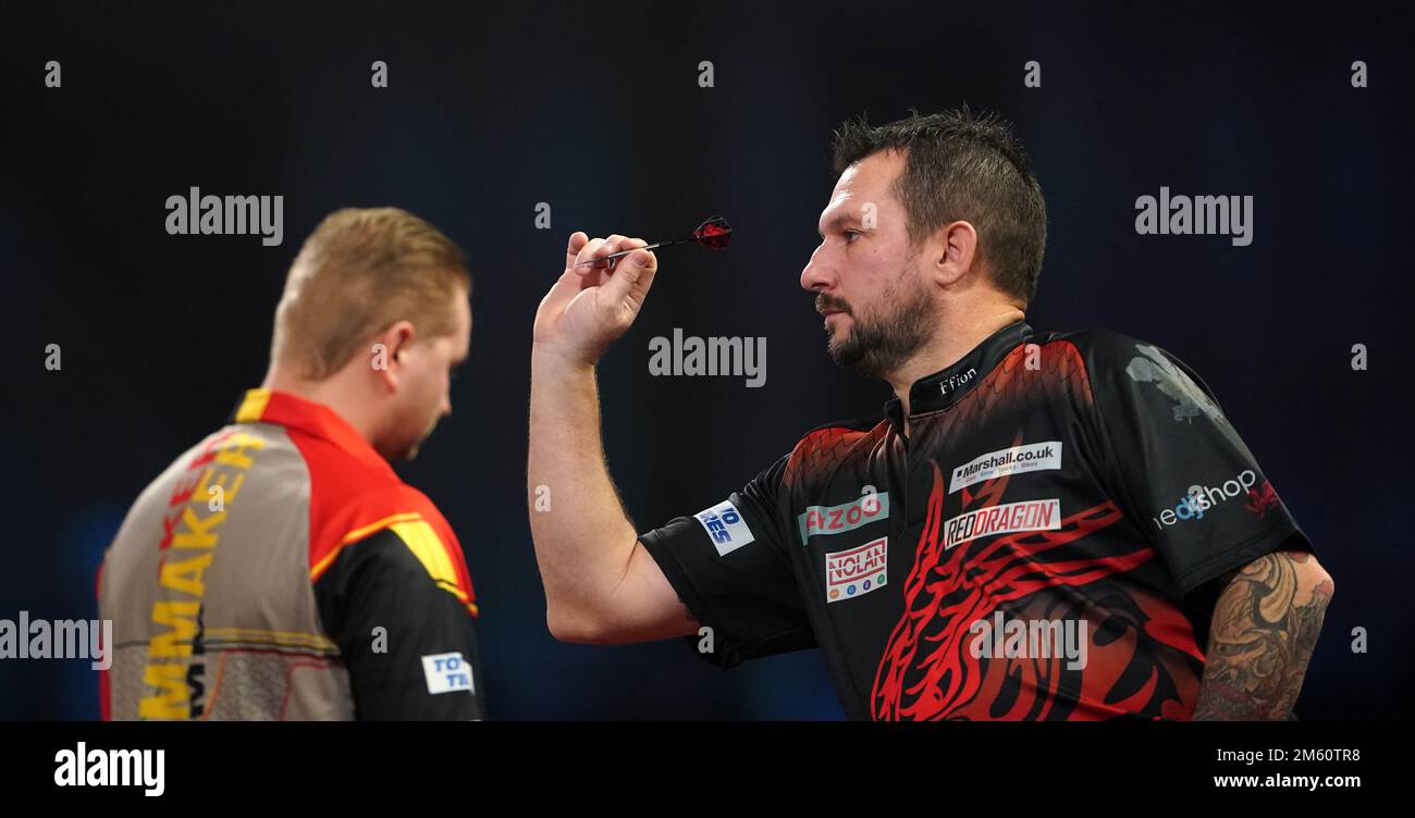 Jonny Clayton in action against Dimitri Van den Bergh during day ...