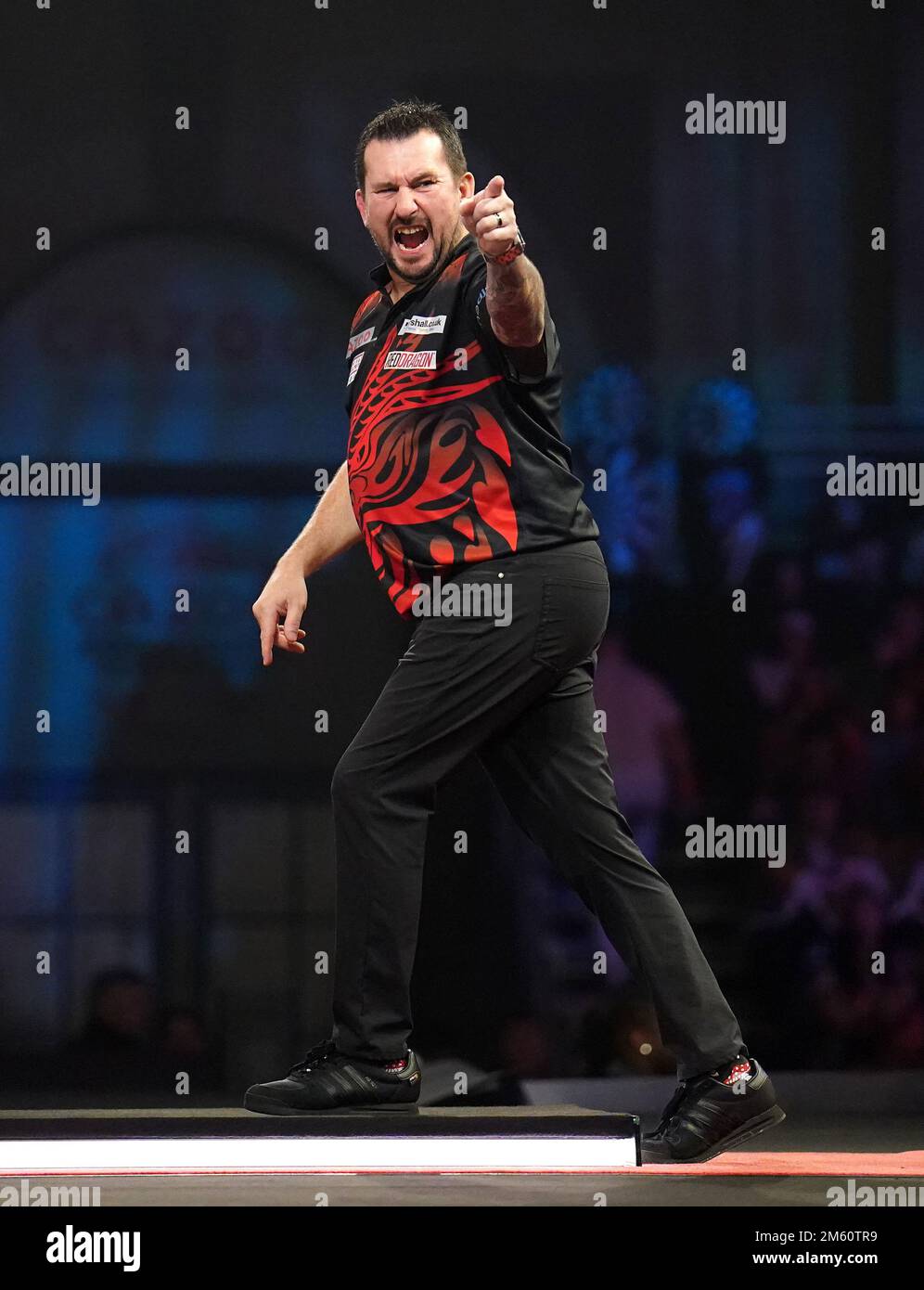 Jonny Clayton in action against Dimitri Van den Bergh during day ...