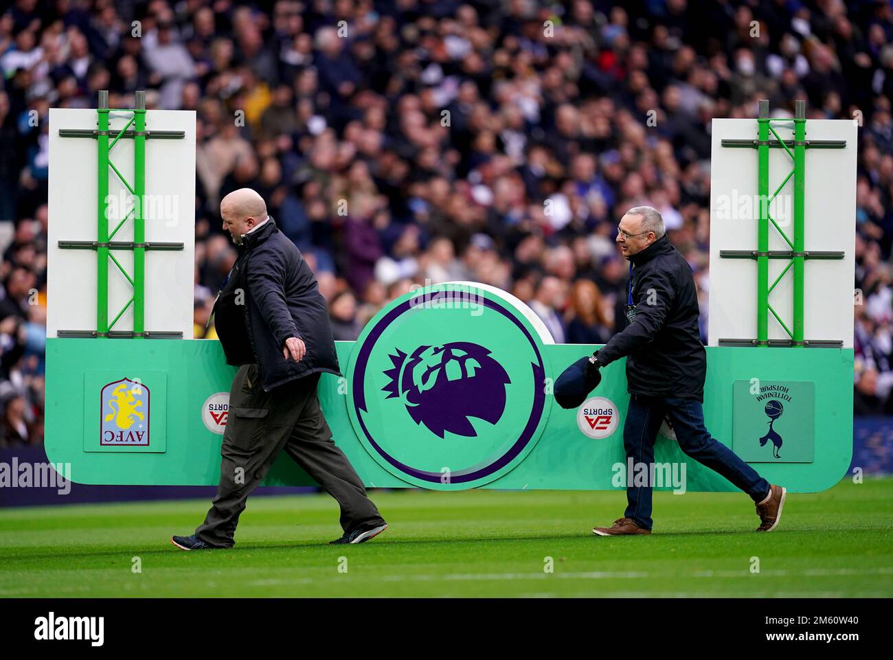 Staff carry Premier League signage off of the pitch ahead of the ...