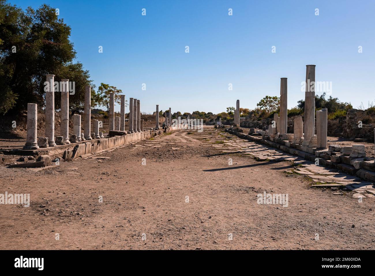 Old ruins of columns in a row on landscape under clear sky blue in ...